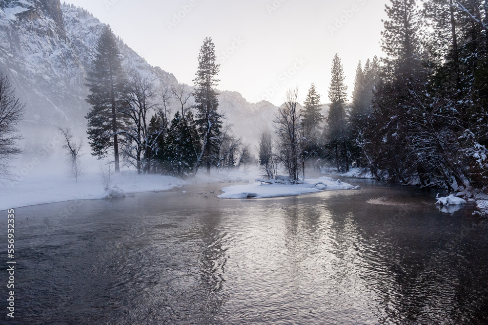 Yosemite valley is enshrouded in a thin layer of mist hanging over the ...