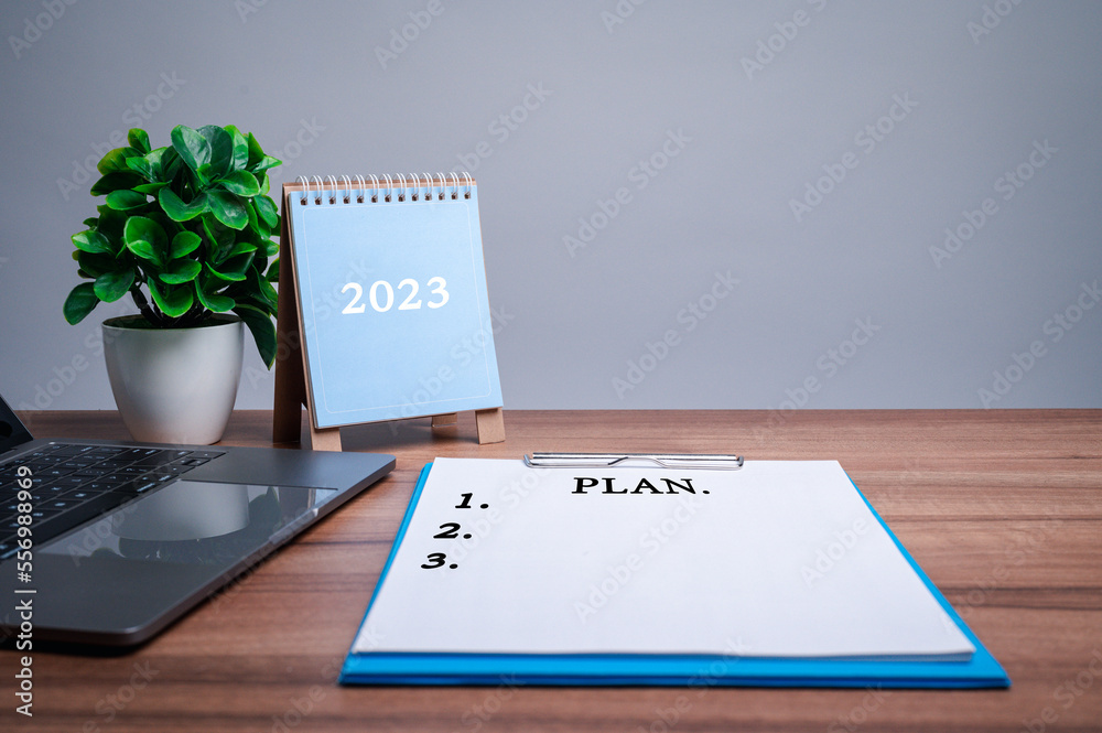 Desktop calendar for 2023 on desk beige. plans and goals on next year ...