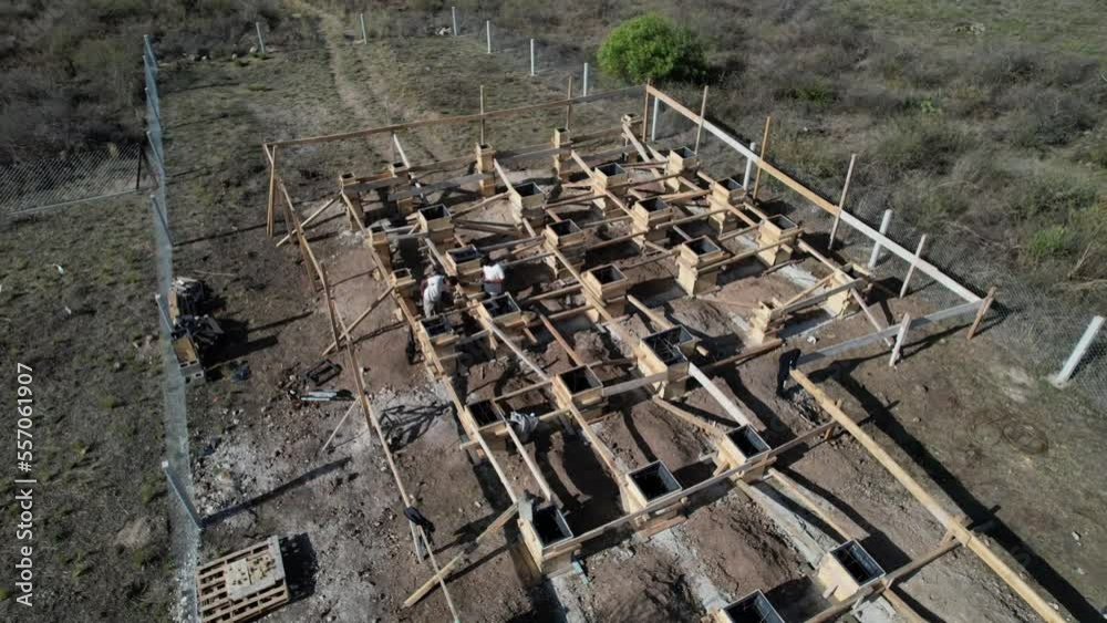 Filling of concrete piles for container houses. Aerial drone top view ...