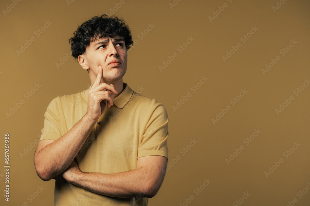 Thinking man looking up and around on yellow background. Worried ...