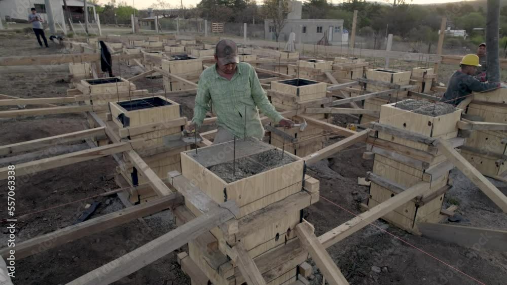 Filling of concrete piles for container houses. Aerial drone top view ...