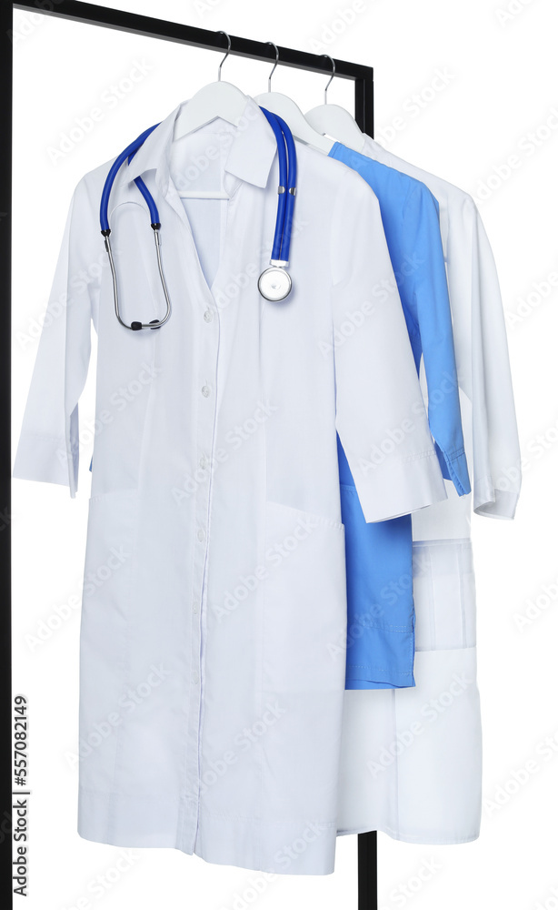 Doctor's gown with stethoscope and different medical uniforms on rack ...