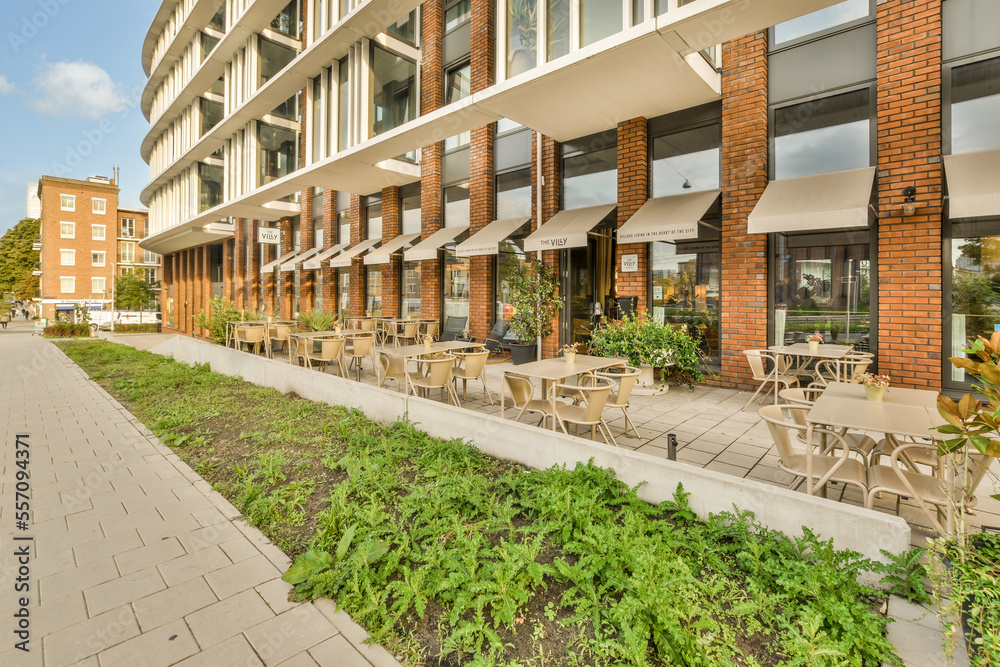 an outside area with tables, chairs and umbrellas on the sidewalk in ...