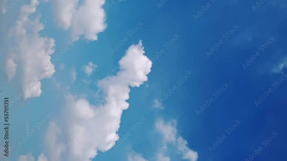 Seamless loop of fluffy clouds in a blue sky in a summer shot on a ...
