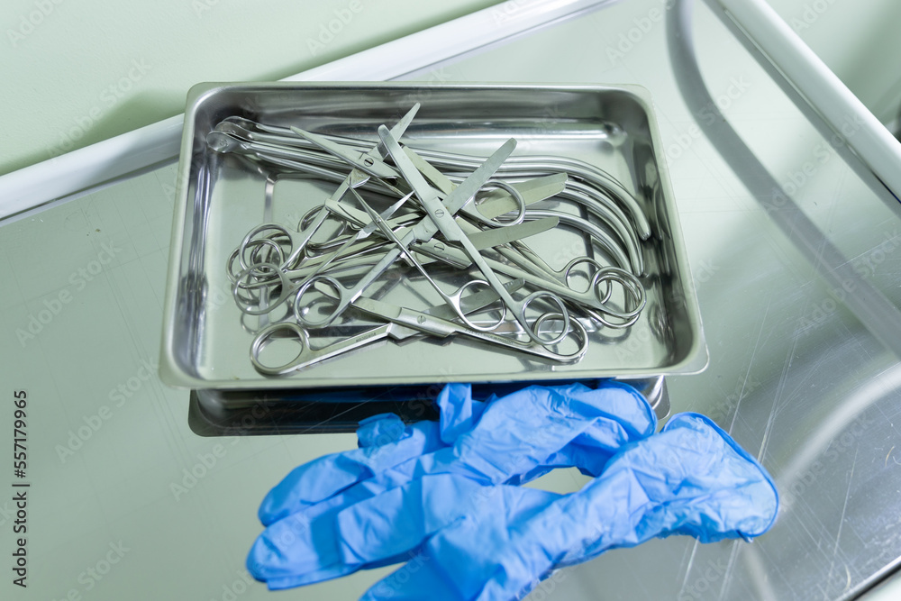 surgical instruments sterile in a tray on a medical metal table ...