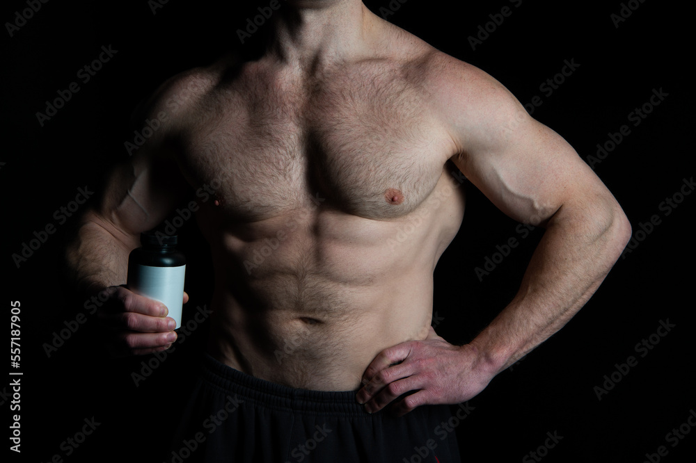 muscular bodybuilder with supplement jar. photo of muscular bodybuilder ...