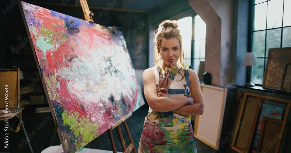 Confident modern woman artist looking at camera and smiling standing ...