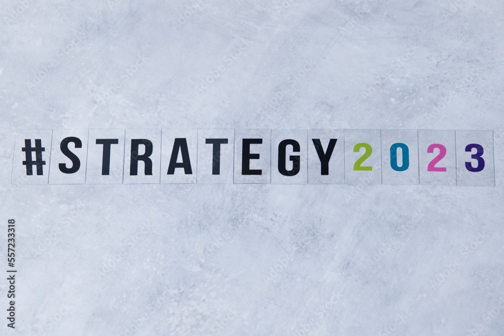 Capital letters on concrete background saying "#strategy 2023 ...