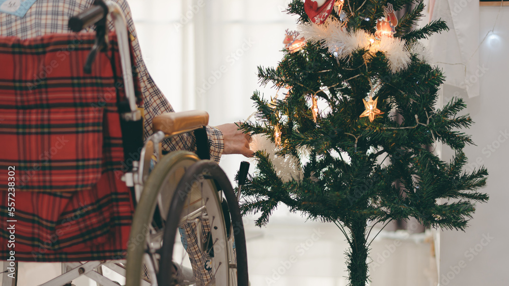 Hand of teenage boy with disability on wheelchair holding Christmas ...