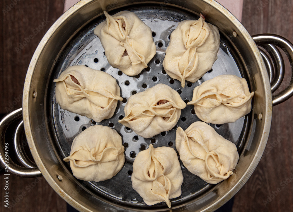 Manti in a pressure cooker. Stock Photo | Adobe Stock