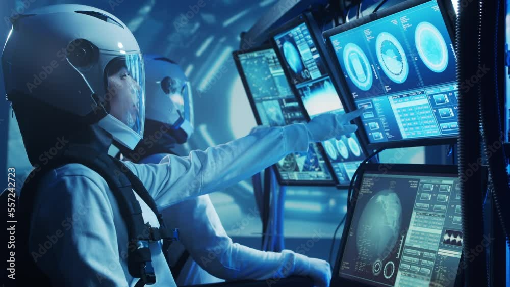 Team of astronauts in a space suits aboard the orbital station. A crew ...