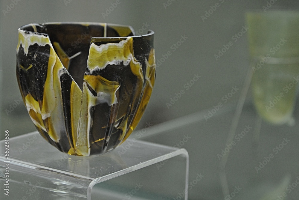 Ancient renovated bowl made of polychrome glass strips of brown, black ...