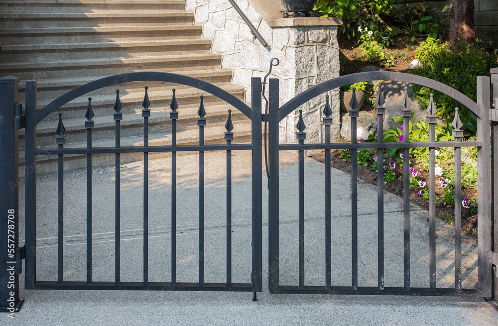 Metal black gate. Black metal garden entrance gates set in fence ...