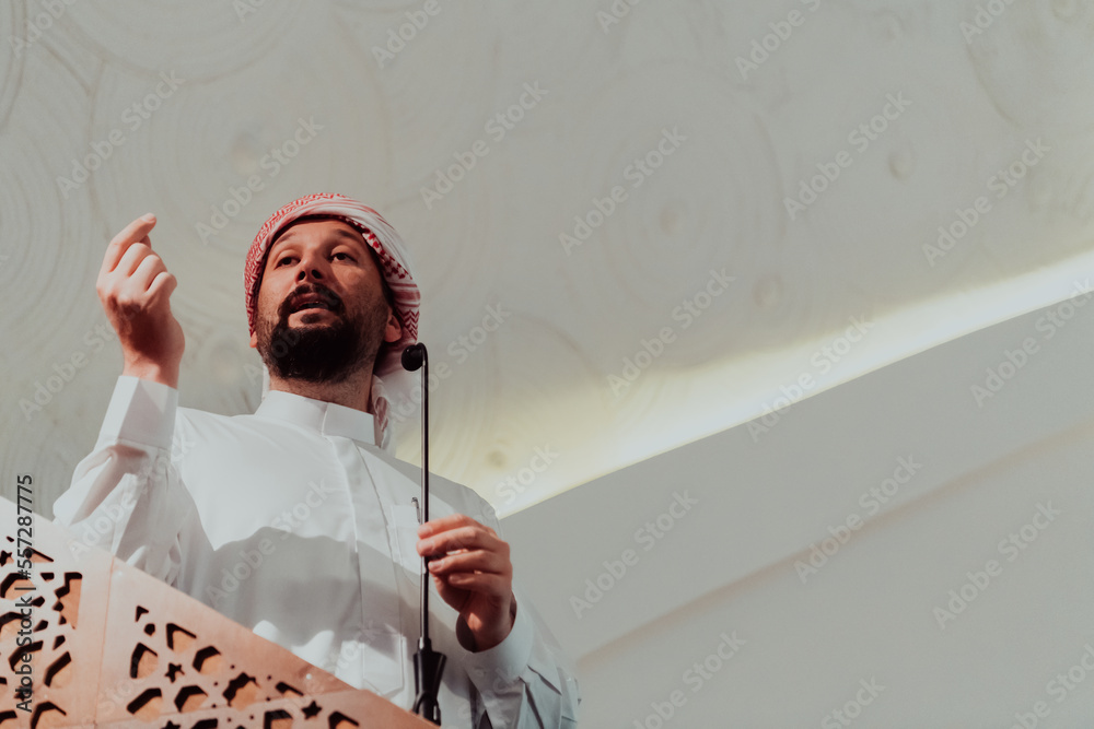 Muslims arabic Imam has a speech on friday afternoon prayer in mosque ...