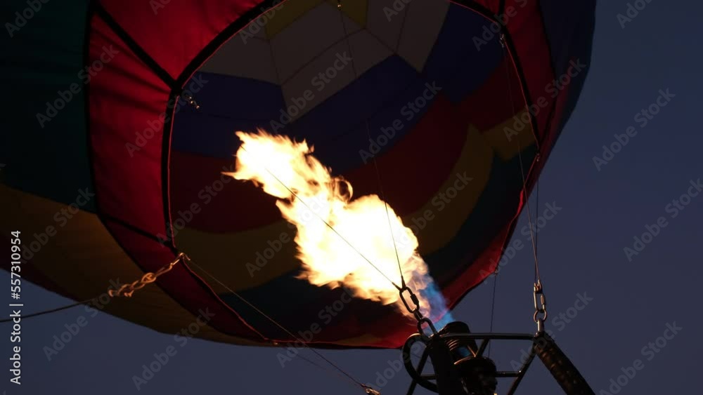 Gas burner blowing up hot air balloon. Slow motion scene of flames ...