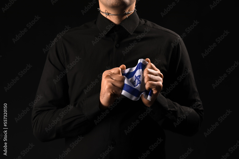 Jewish man with barbed wire around his neck holding flag of Israel on ...