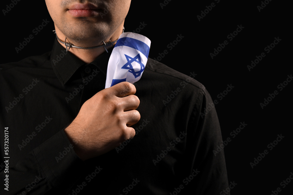Jewish man with barbed wire around his neck holding flag of Israel on ...