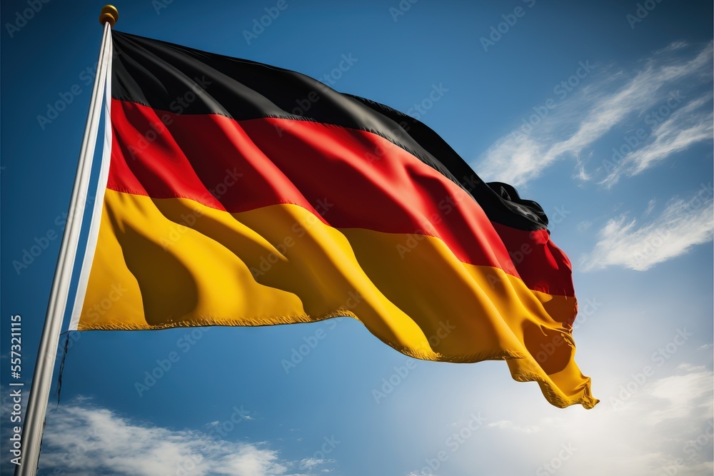 a german flag flying in the wind with a blue sky in the background with ...