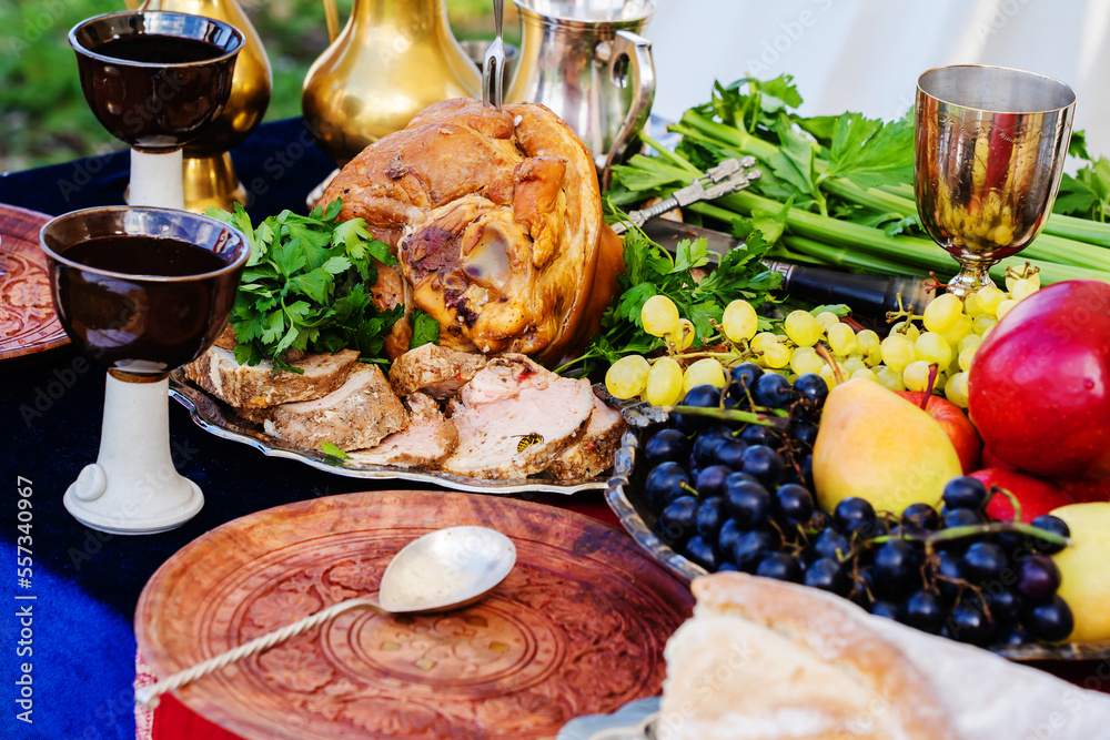 Fotografia do Stock: A laid table in a medieval style. Pork meat on a ...