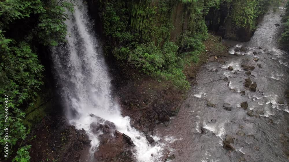 Water flow rush down from tropical thickets, aerial shot of waterfall ...