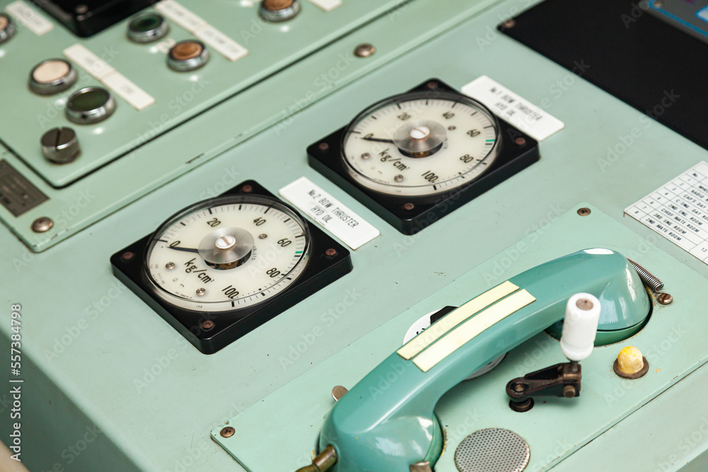 Boat control panel with analog corded telephones, buttons, switches and ...