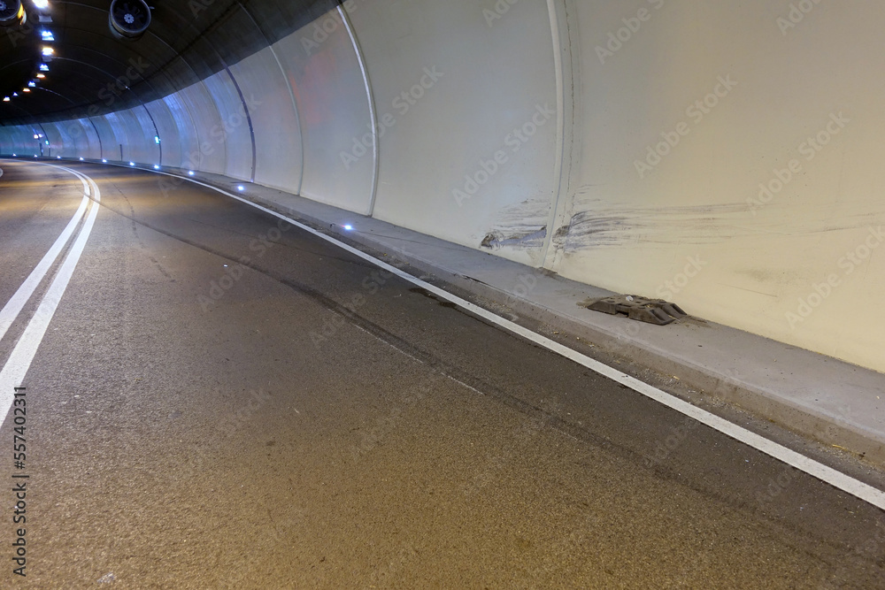 Skid and impact marks in a road tunnel after an accident of a car that ...