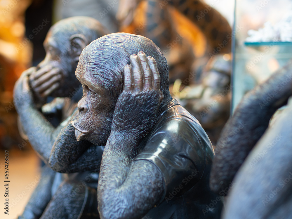 Statue of monkey holding hands on ears. Stock Photo | Adobe Stock