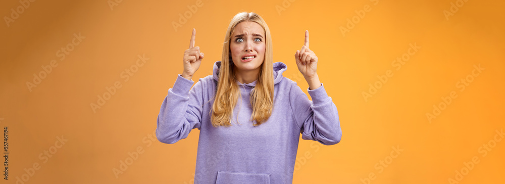 Worried perplexed unsure cute blond woman presenting project standing ...