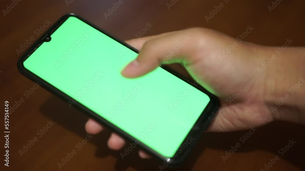 Man finger touching and scrolling mobile phone with green screen ...