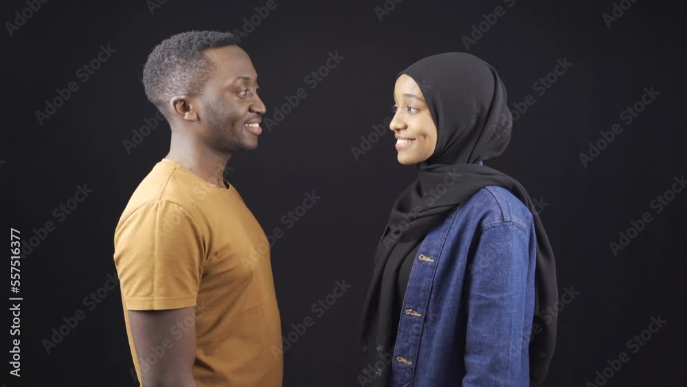 Affectionate african muslim couple loving looking at camera and smiling ...