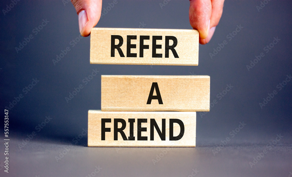Refer a friend symbol. Concept words Refer a friend on wooden blocks on ...