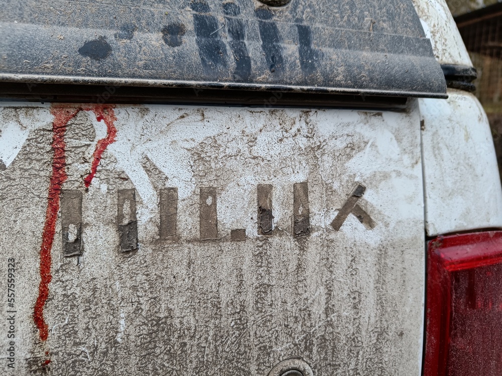 A dirty back door of a Toyota Hilux car with a blood mark on it. Blood ...