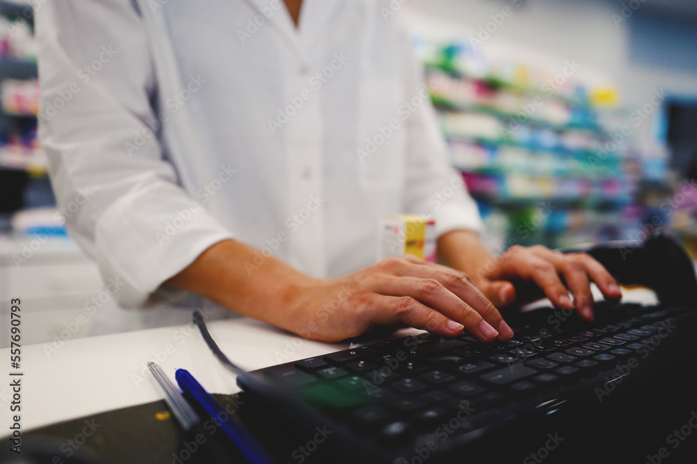 Pharmacist woman works at computer at the pharmacy counter Stock Photo ...