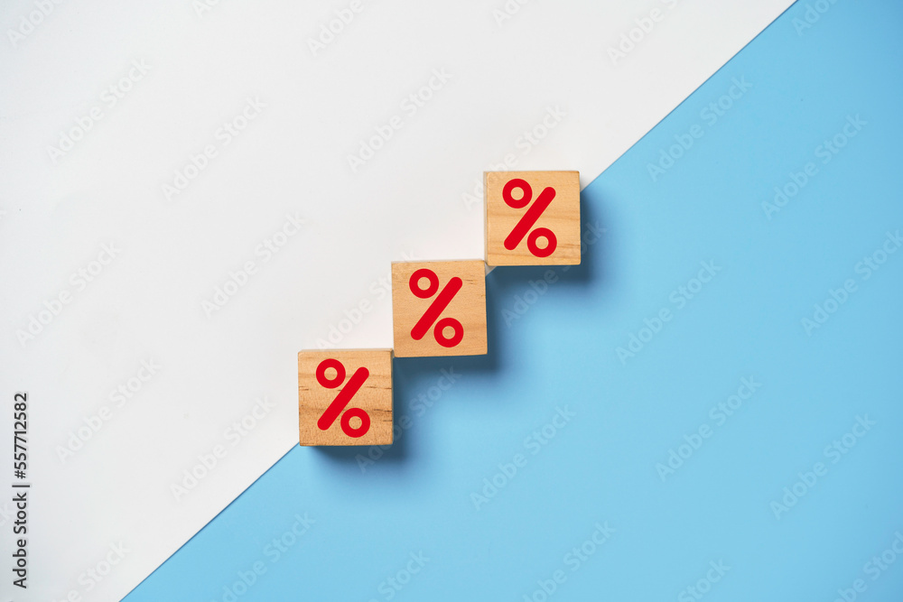 Red percentage sign print screen on wooden cube block on white and blue ...