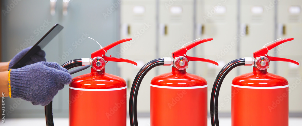 Fire extinguisher has hand engineer inspection checking pressure gauges ...