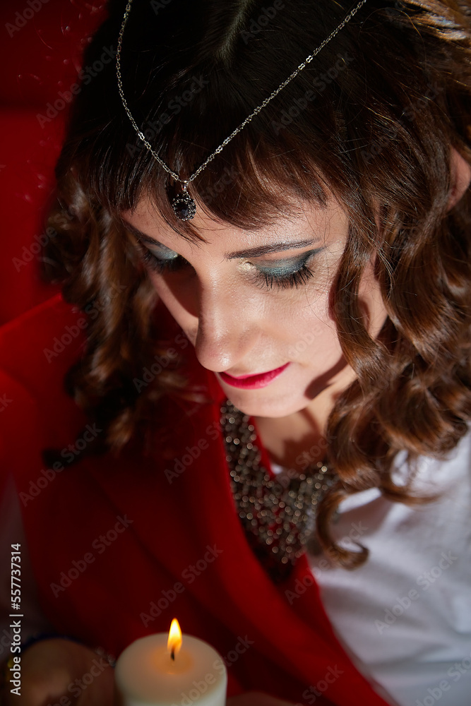 Foto de Beautiful arabian girl with candles in red room full of rich ...