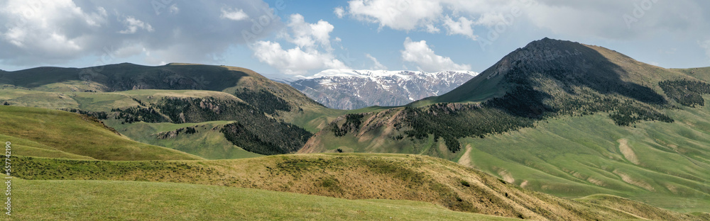 Kyrgyzstan nature green landscape with vast mountains. Kyrgyzstan is a ...