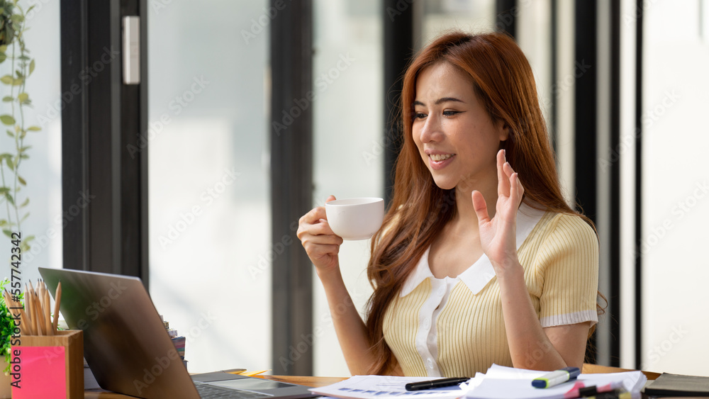 Happy positive young asian woman enjoying online communication at home ...
