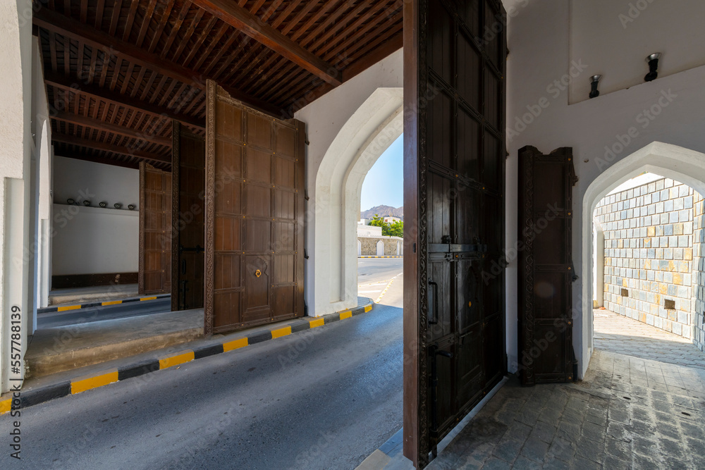 The large, carved wooden doors and arched gates under the Omani Gate ...