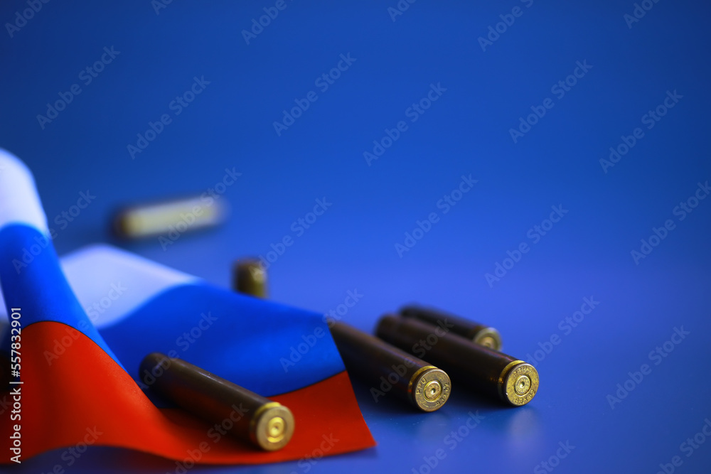 Russian flag and bullet casings on the table. Background concept ...