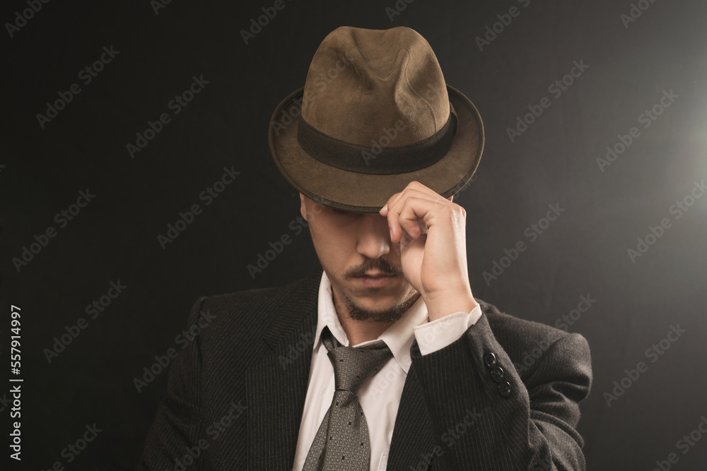 Old school mobster in a retro hat. Stock Photo | Adobe Stock