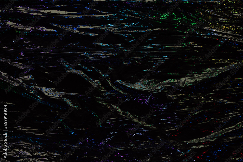 Black color plastic wrap background. Dark crumpled wrinkled plastic ...
