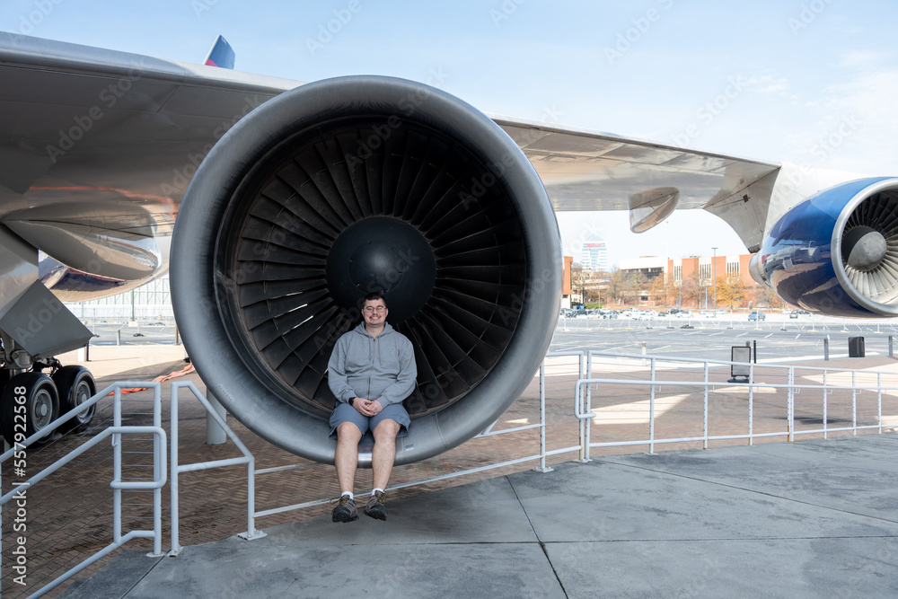 A middle aged white male sitting inside of a jet engine from a four ...