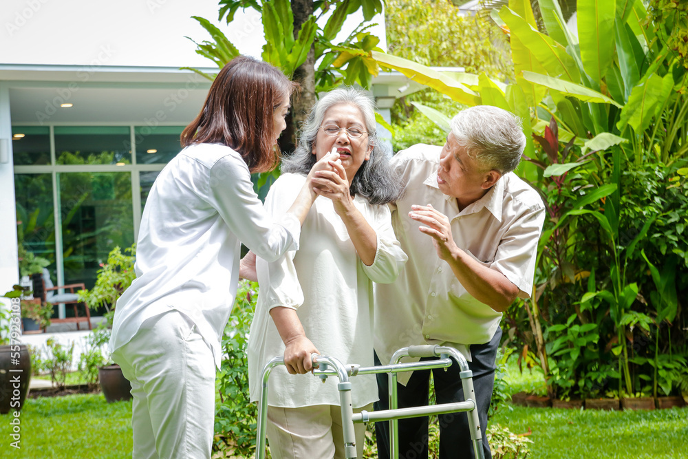 Family concept. Daughter and father taking care of elderly mother Give ...