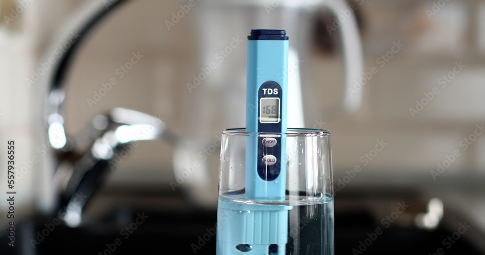 Measurement of TDS of water. Electronic pH meter in a glass of water ...