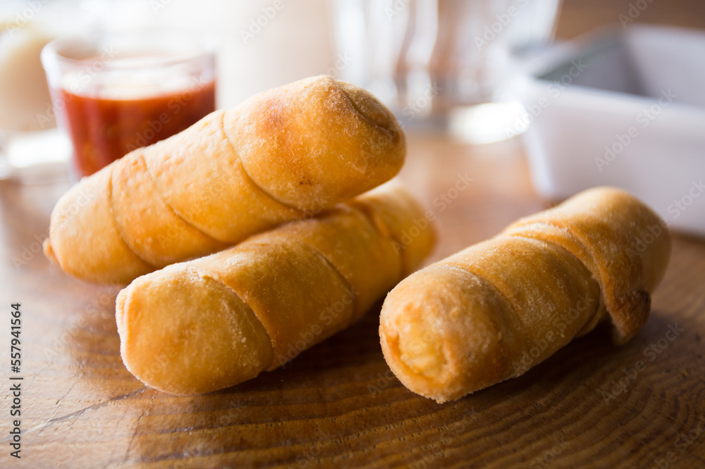 Tequeño is a fried breaded cheese stick or bread dough spear with white ...