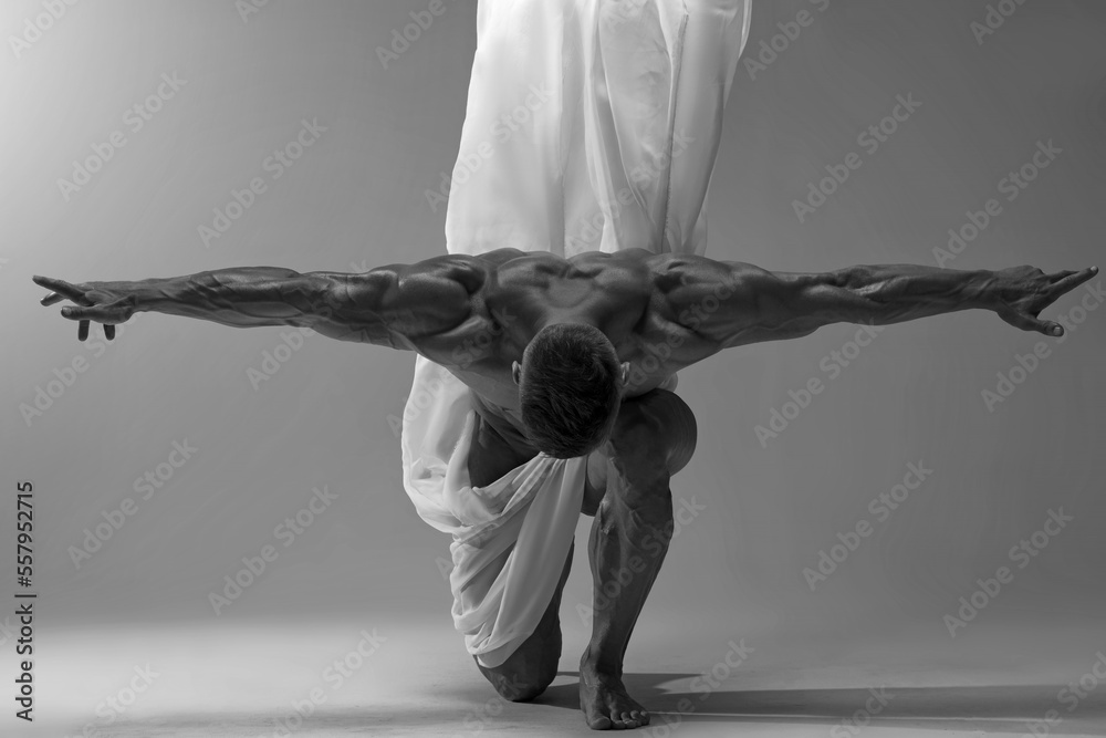 Muscular faceless shirtless man posing kneeling in studio Stock Photo ...