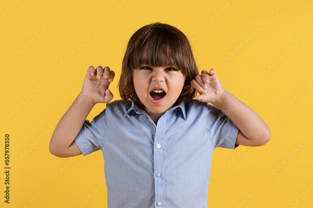 Kids aggression. Angry little boy threatening to camera, showing ...