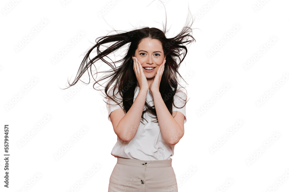 Excited brunette Italian young woman with fluttering hair in casual ...