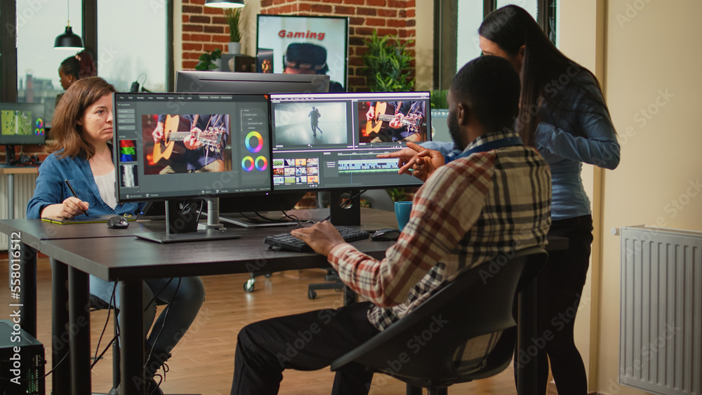 Team of artistic content creators editing movie montage on software ...